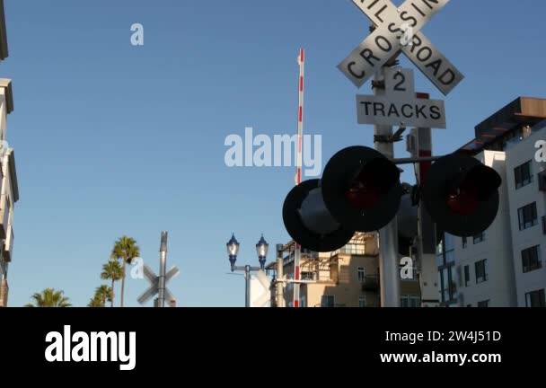 Level crossing warning signal in USA. Crossbuck notice and red traffic ...