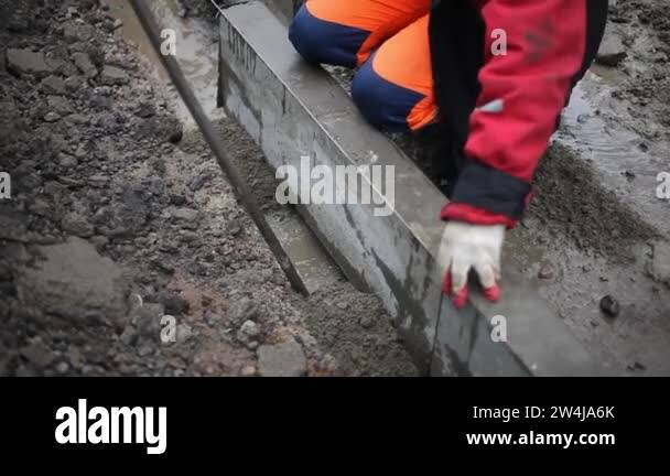 Road repair. Installation of curbs on the highway. The workers are ...