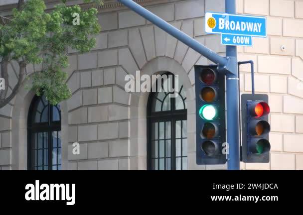 Broadway street name, odonym sign and traffic light on pillar in USA ...
