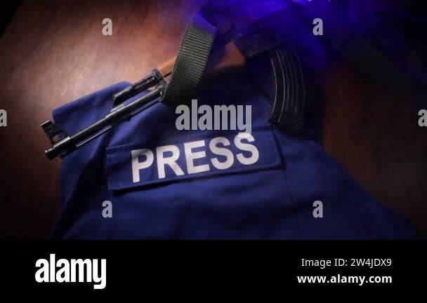 close-up footage of protective press vest with ak-47 gun on wooden ...