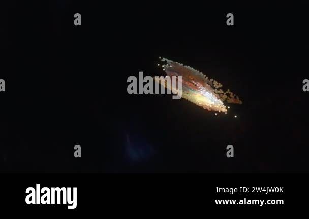 Abstract many glow dust particles moving and transform into spiral ...