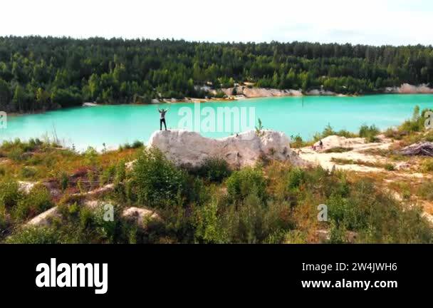 Landscape of a light blue lake surrounded by forest - a successful man ...