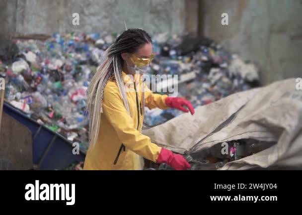 Woman-volunteer in yellow and transparent protecting glasses sorting ...
