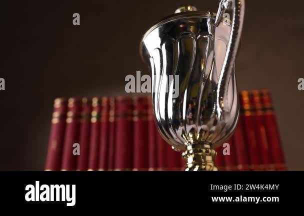 silver trophy for the first place spinning in front of red books in a ...