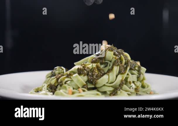 Cooking in restaurant, Chef serves cooked macaroni pasta pouring with ...