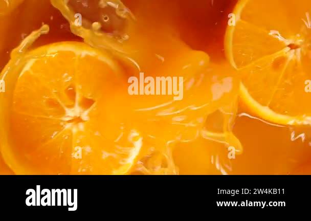 Orange falling and splashing into orange juice and is divided into ...