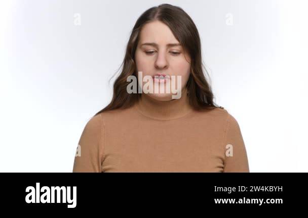 Upset and stressed woman shaking head and making facepalm gesture ...