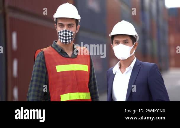 Labor man worker is wearing protection mask face and safety helmet at ...