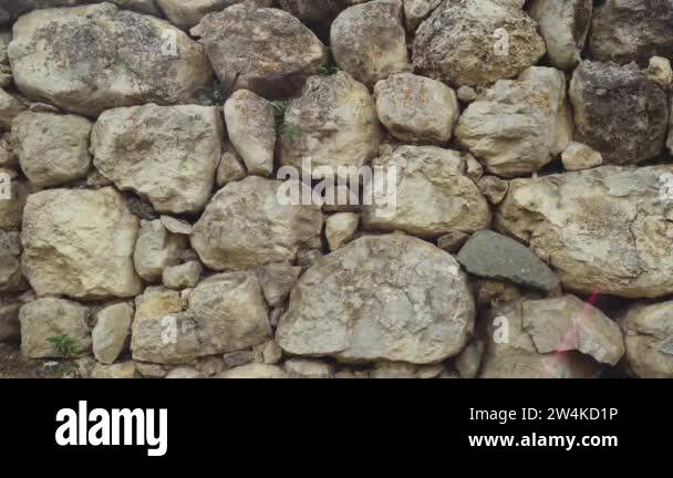 Texture of old stones of various forms with seams. Close up of shabby ...