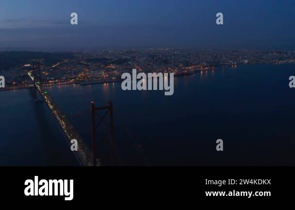 Night panoramic aerial view of town on rivershore. Light of cars ...