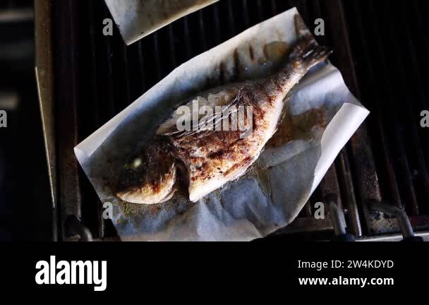 Sea bass fish grill for dinner in seafood restaurant.Cooking whole ...