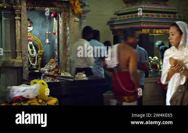 Hindu priests and worshippers inside a temple in the Indian district of ...