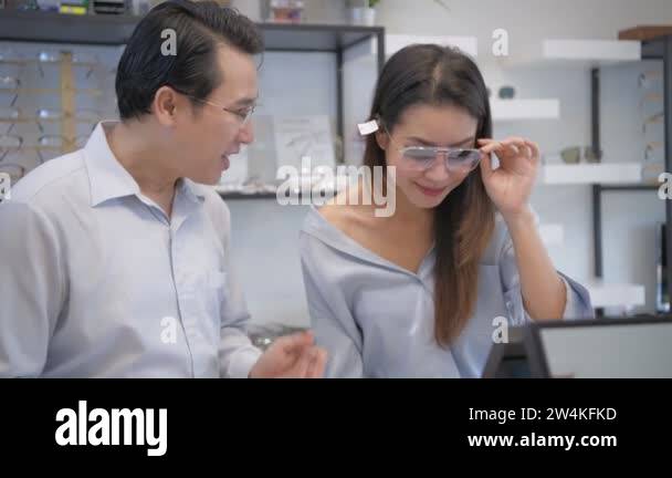 Optical shop concept. Customers are paying with their mobile phones. 4k ...