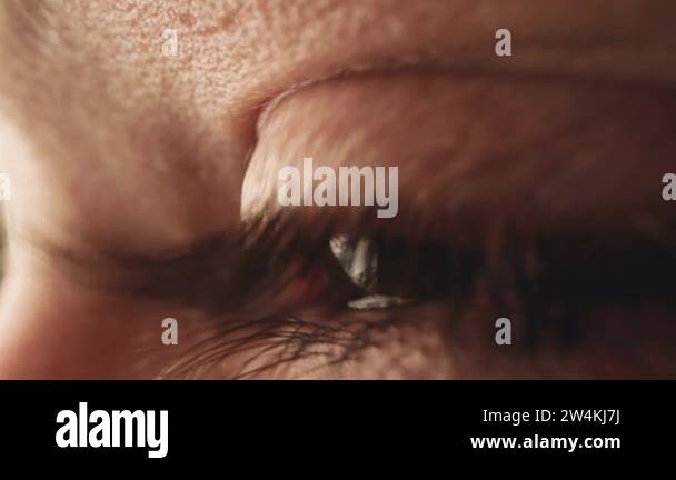 Extreme close-up of a blinking eye in slow-motion and 4K resolution ...