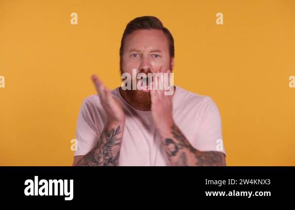 A bearded man warms up, breathing quickly, flexing, clapping himself on ...