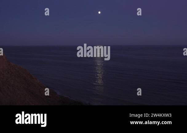 The full moon illuminates the water surface. Moon track on the surface ...