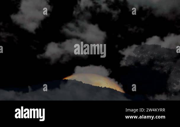 super full blood moon rise back dark cloud on the night sky time lapse ...