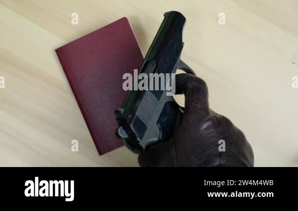 A hand in black glove putting nternational passport of the Russian ...