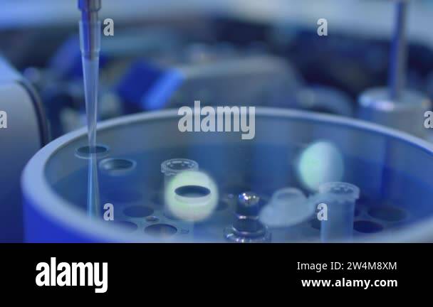 Apparatus for automatic sampling, analysis. A robo hand takes a sample ...