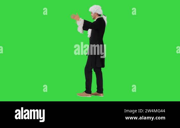 Man dressed like Wolfgang Amadeus Mozart conducting an orchestra on a ...