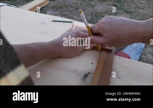 Measuring dimensions with a ruler during construction from wood Stock ...