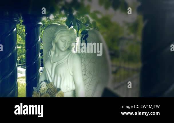 Figure of a praying angel. A very ancient stone statue. . Sad angel as ...