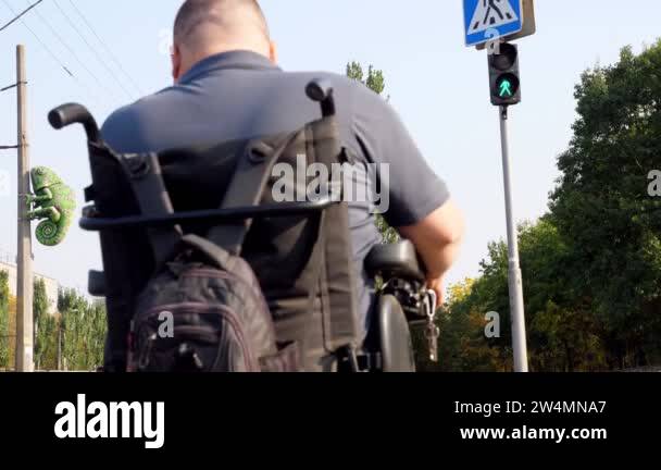 wheelchair man. Handicapped man. back view. young disabled man on ...
