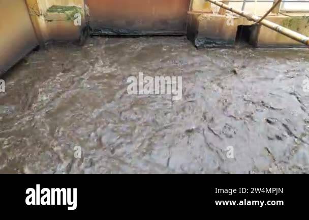 Sludge gate. Swirl of municipal sludge in the tank to complete the ...
