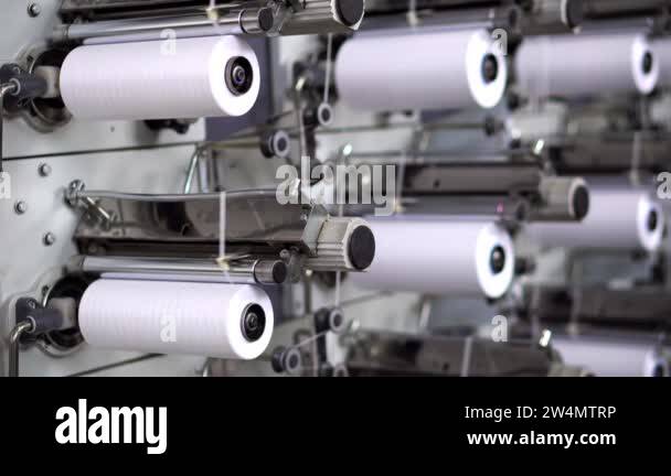 Fabrication and winding of flat thread. The heated mixture passes ...