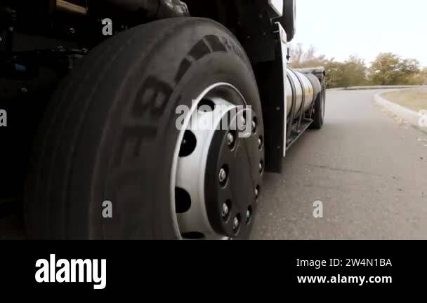 Freight semi truck driving and turning fast on empty highway. Scene. Close up of rotating car ...