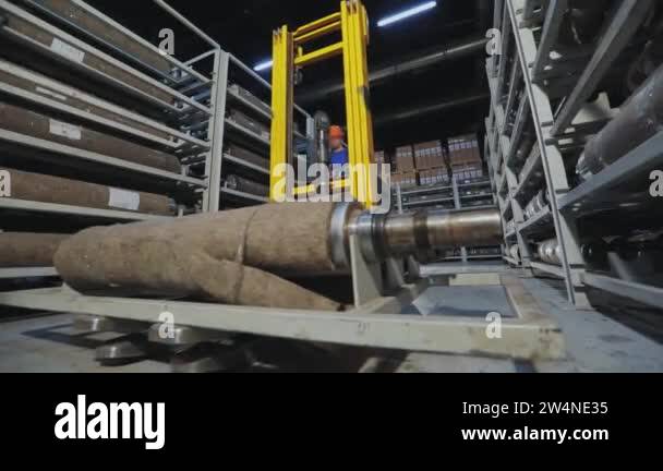 Modern wallpaper production. White man worker pushing stacker with ...