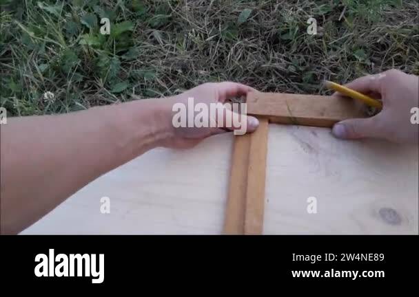 Measuring dimensions with a ruler during construction from wood Stock ...