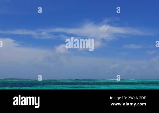 Daytime tourism of marine tourist beach break by blue green sea with ...