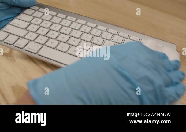 Cleaning the desktop keyboard in the office, maintaining hygiene ...