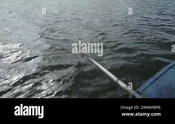 Boating on the big river. One paddle is visible close-up. Clear water ...