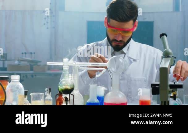 In front of the camera concentrated scientist man working in his ...