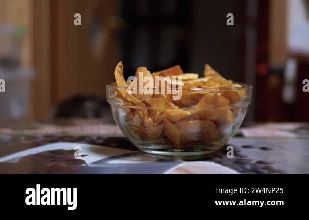 Hungry Teen Steals Potato Chips from Table in a Plate While No One Sees ...