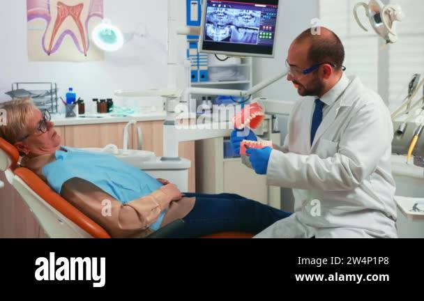 Explaining procedure using model of dental teeth Stock Video Footage ...