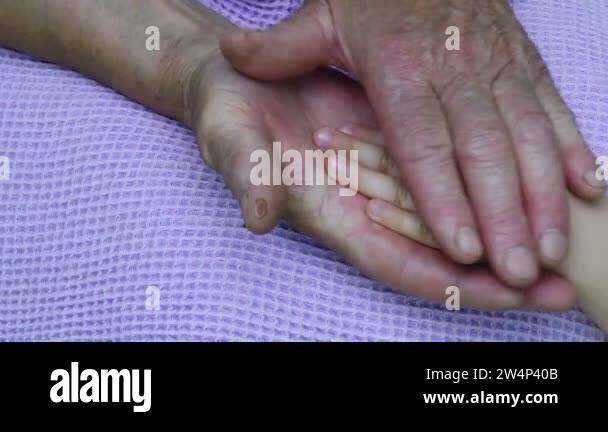 Little hand in old hands pating gentle. Granny hand and kid hand ...