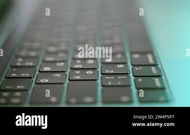 Side view of laptop or computer details, black keyboard with white ...