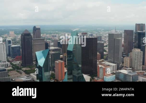 Forwards flying drone towards modern tall buildings at Fountain place ...