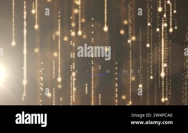 Animation of golden star light strands falling in hypnotic motion in seamless loop with lens ...