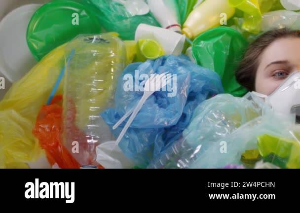 Panning top-view footage of young caucasian girl lying in tons of ...