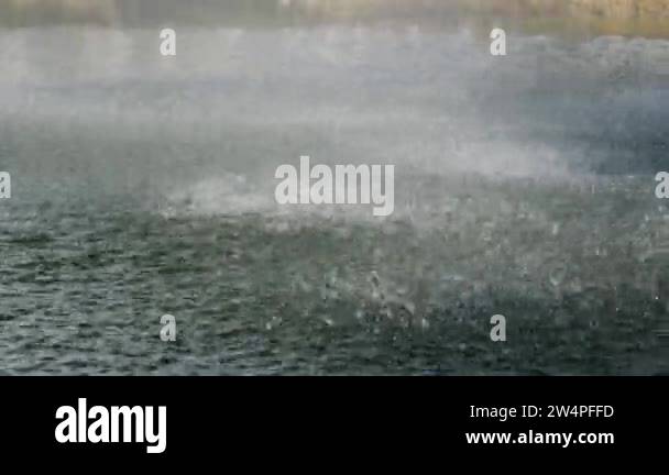 Very heavy rain in windy weather. Lots of raindrops falling on the ...