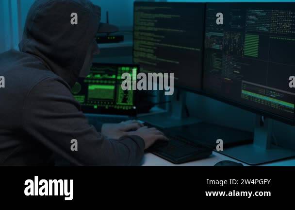 Unrecognizable Man Hacker Wearing Sweatshirt With Hood Typing On