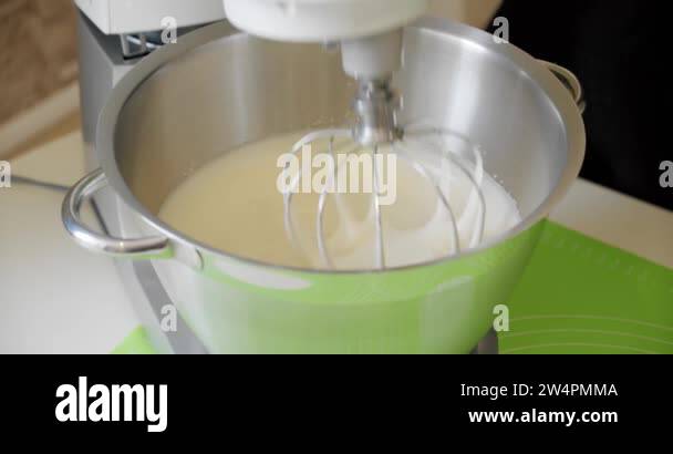Mixer Whips Milk Cream for Cake. Professional baker preparing the cake ...