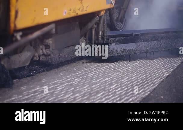 Asphalt paver applying asphalt on the highway. An equipment used to ...
