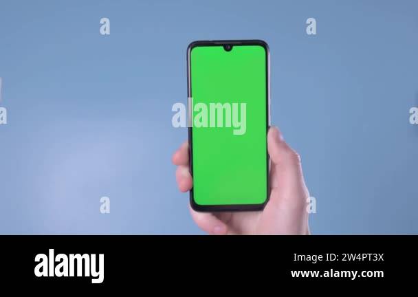 man's hand holding a mobile telephone and scrolls swipes to the right with a vertical green ...