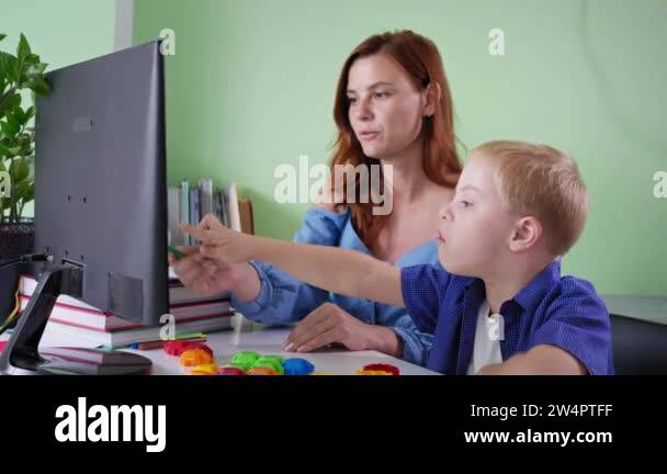 pupil homeschooled, schoolboy with down syndrome doing school homework ...