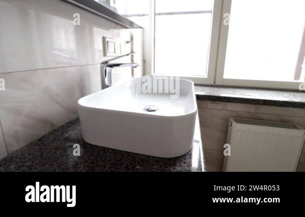 Water flows from the tap . White shell. The interior of the bathroom ...